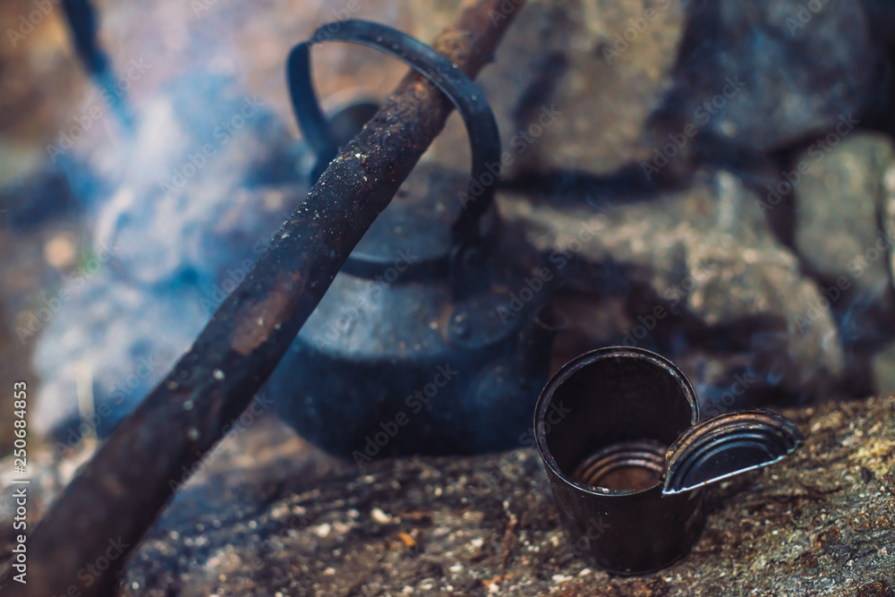 Extinguished bonfire with kettle on large firewood. Extinct bonfire ...