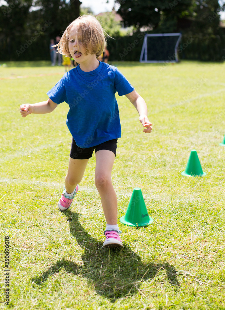 girl running around cones at her school sports day Stock Photo | Adobe ...