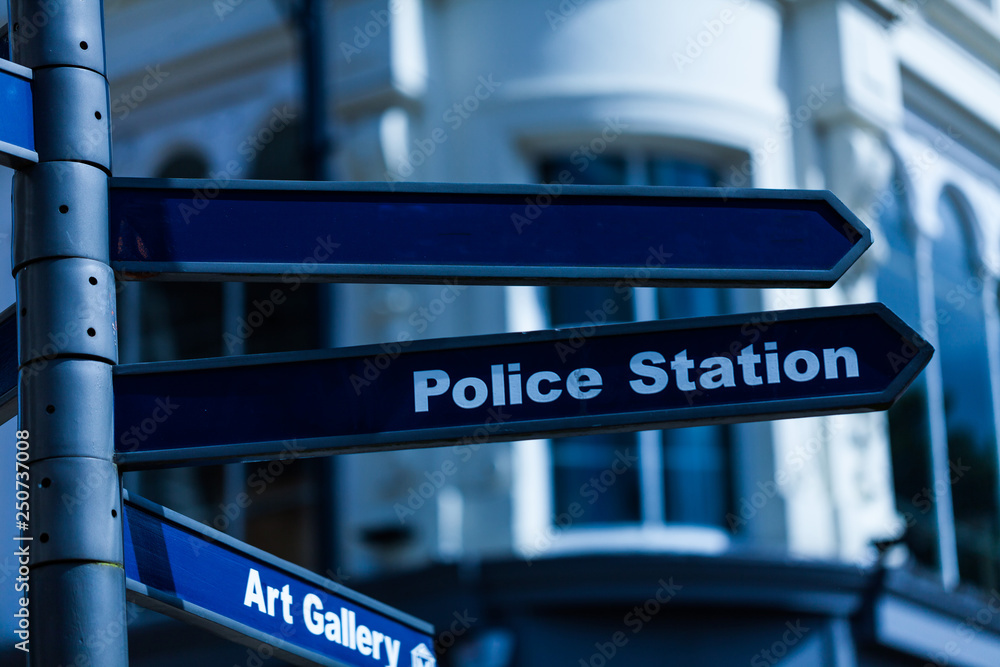 Police station street sign hanging on the lamppost. Arrow sign with ...