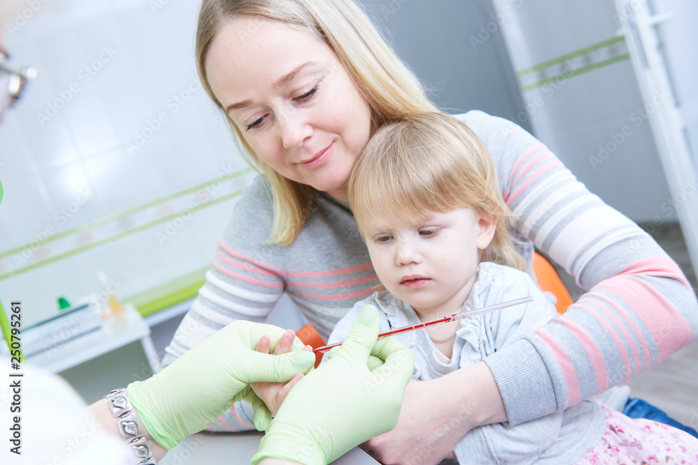 Blood medical test or research. Taking a blood sample from child finger ...