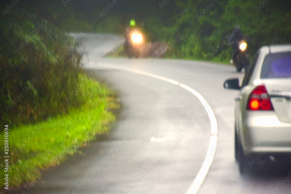 Road Trip. Back view of car on wet road in rainy day at the countryside ...