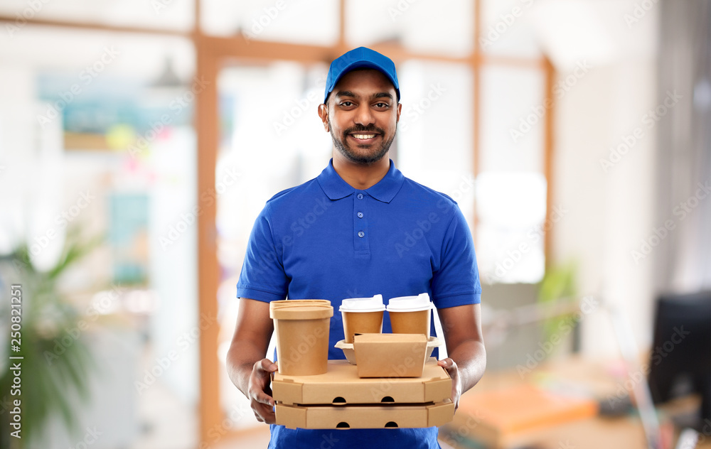 takeaway service and people concept - happy indian delivery man with ...