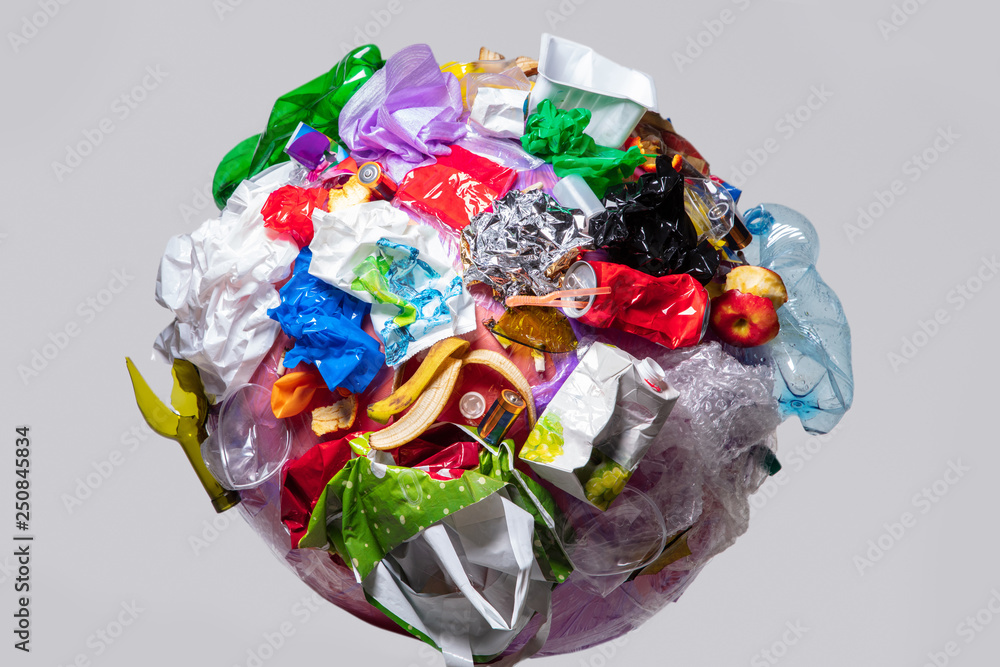 A globe of the earth with trash over white background, the concept of ...