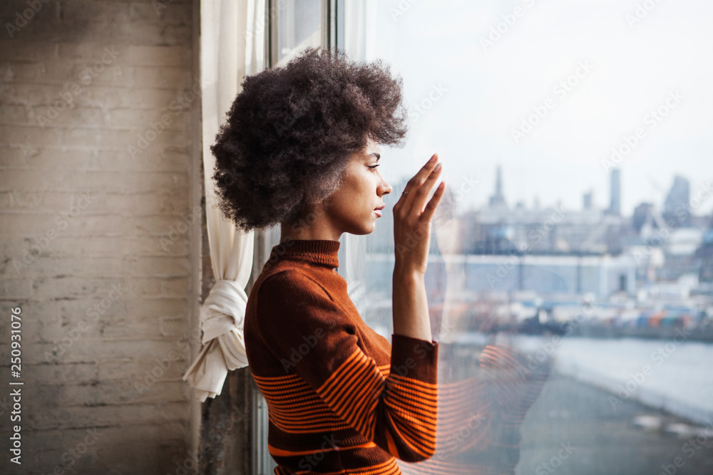 Woman looking through window Stock Photo | Adobe Stock