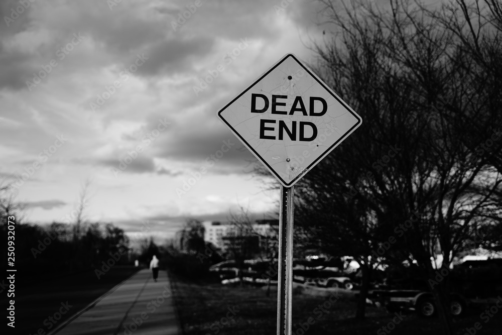 Sign dead end with a man going away behind it b&w Stock Photo | Adobe Stock