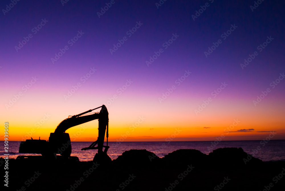 An industrial construction vehicle has been silhouetted against the ...