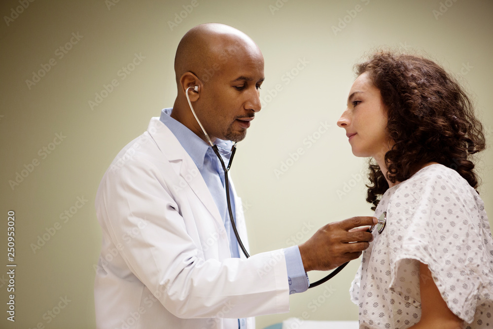 Doctor doing medical examination on female patient Stock Photo | Adobe ...