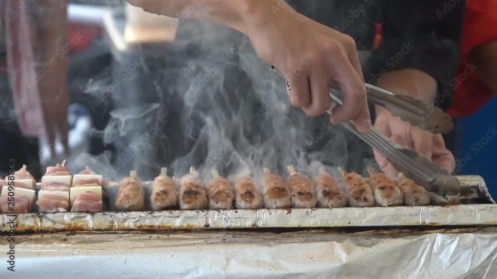 Grilling Japanese Yakitori, a Japanese type of skewered chicken. Stock ...