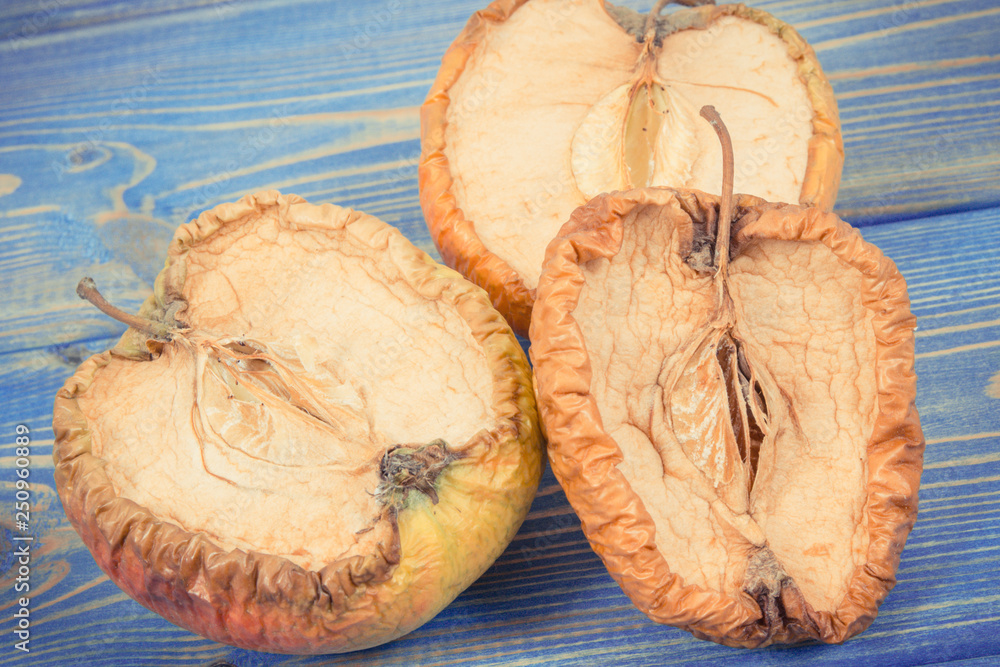 Spoiled apple with mold on boards, unhealthy and disgusting fruit Stock ...
