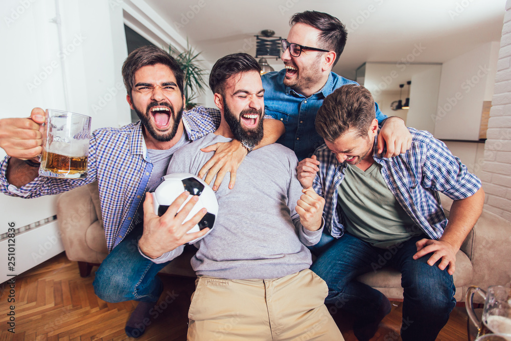 Men watching sport on tv together at home screaming cheerful. Group of ...