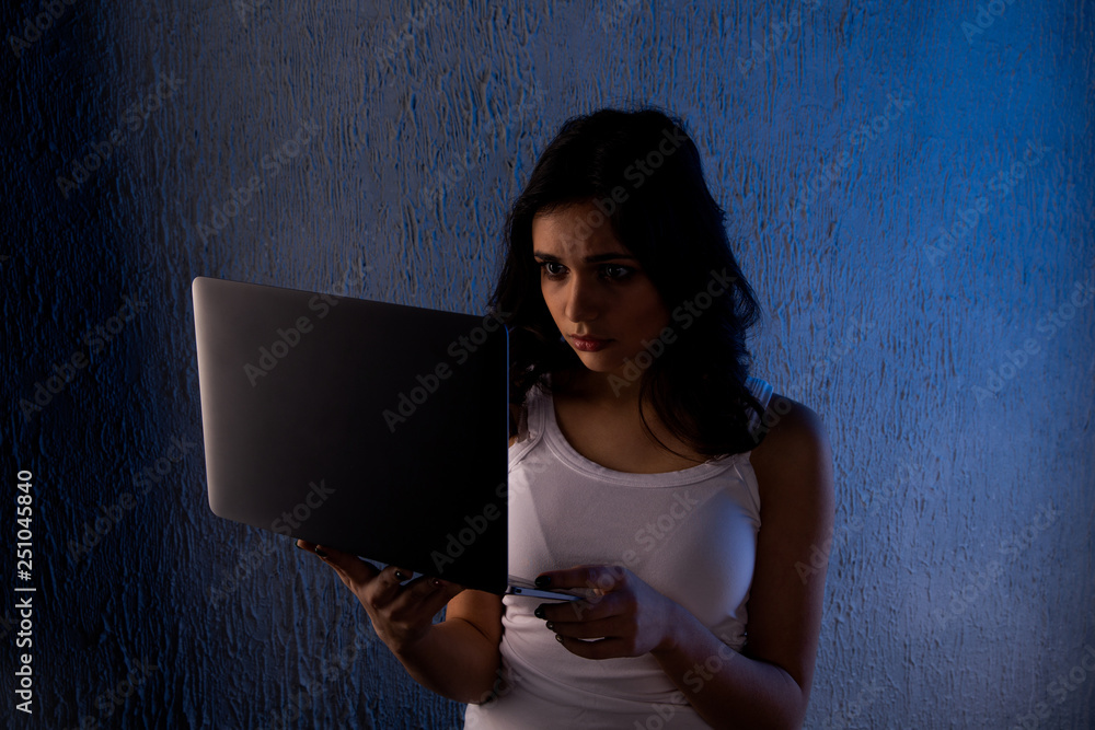 sad and scared female teenager with computer laptop suffering ...