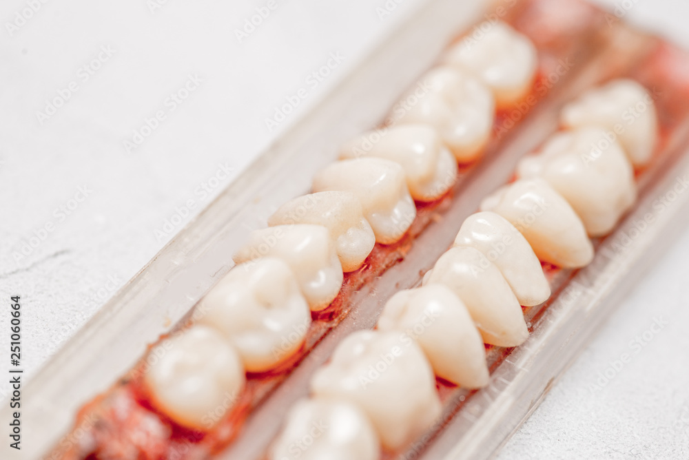 samples of human teeth, dental equipment, enamel color samples on a ...