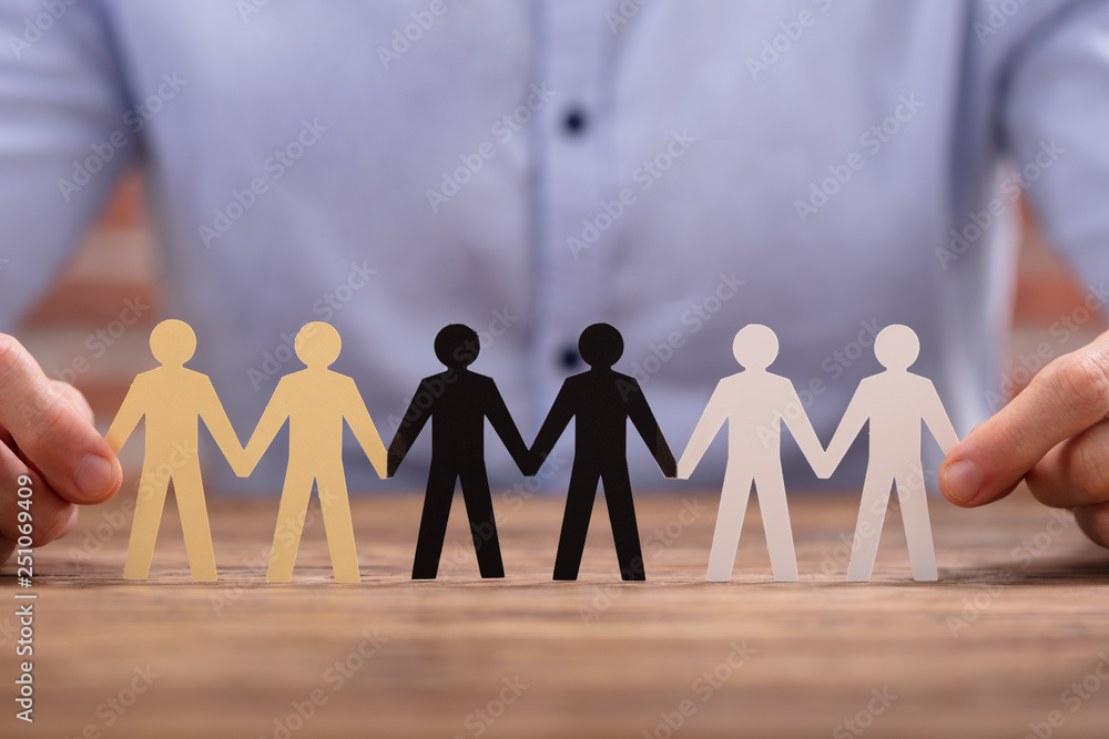 Businessperson Holding Human Figures Stock Photo | Adobe Stock