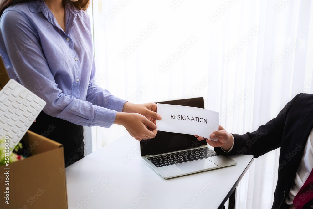 Business woman holding her letter for resignation to manager at office ...