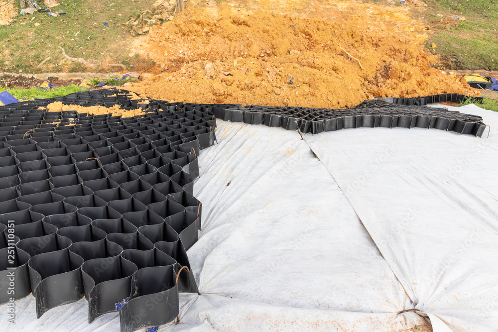 Foto de Slope erosion control grids, sheets and earth on steep slope do ...