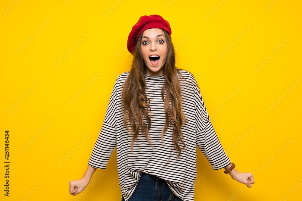 Girl with french style over yellow wall with surprise and shocked ...
