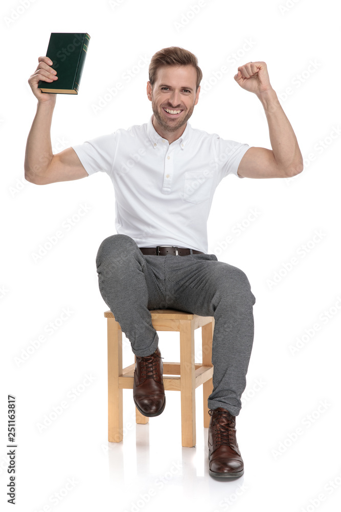 happy casual man sitting on chair celebrates knowledge Stock Photo ...