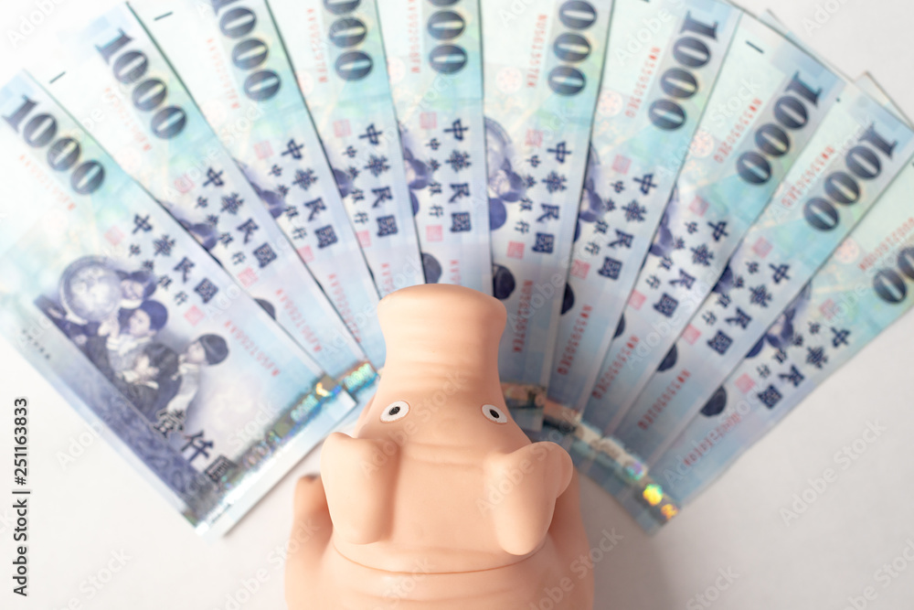 Pile of taiwanese banknotes new taiwan dollar NTD and pink piggy bank ...
