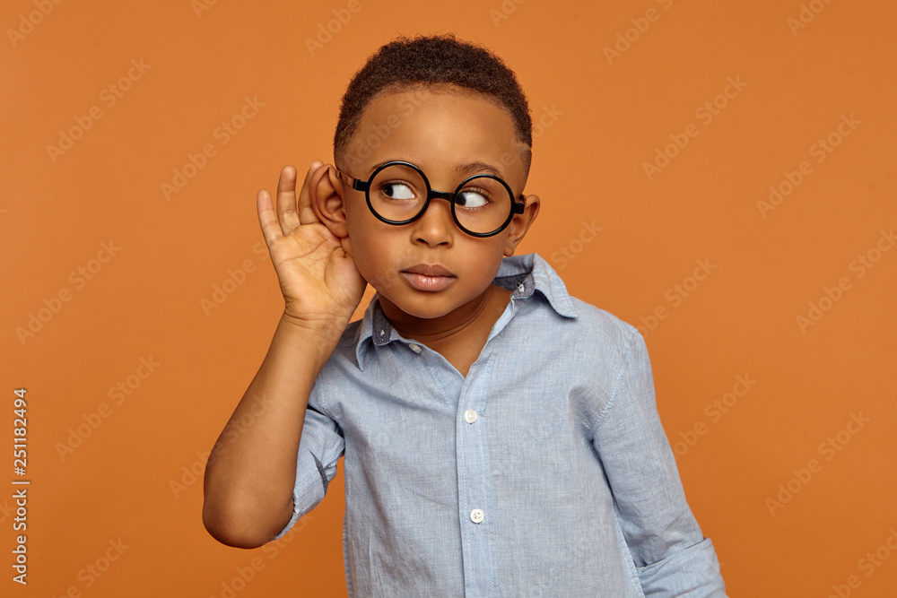 I want to hear everything. Handsome nosy African American little boy ...