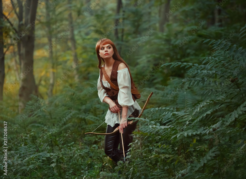 gorgeous lady with long red hair in leather clothes follows wild animal ...