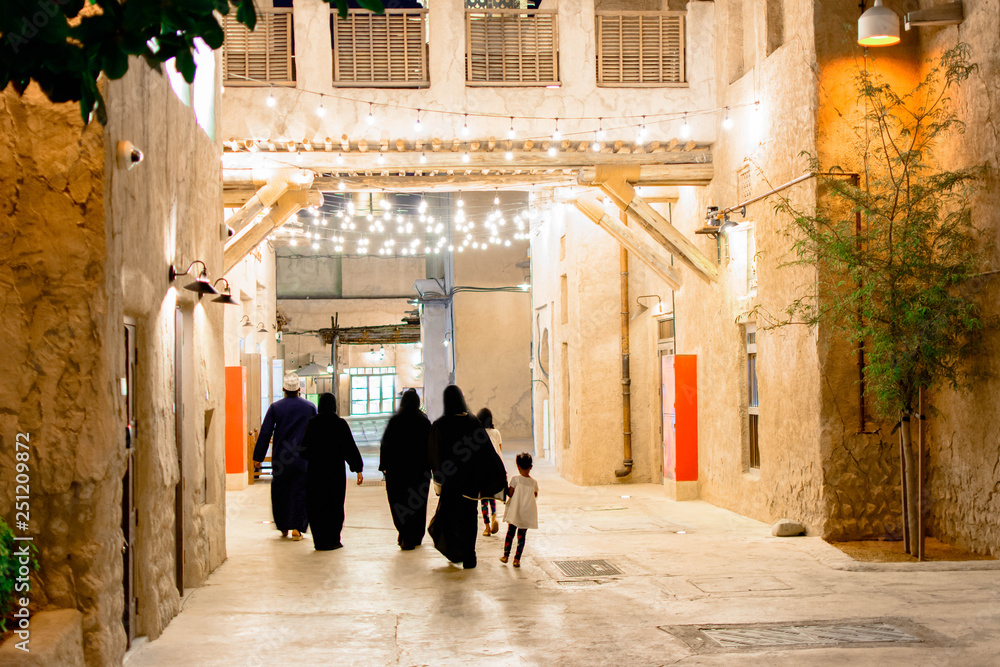Arab People Walking on traditional stone road in between buildings ...