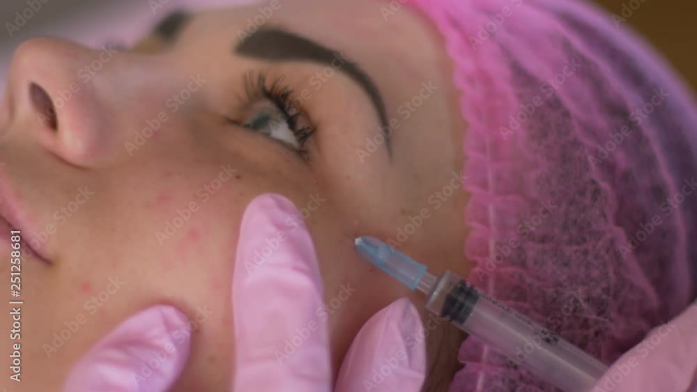 doctor cosmetologist makes Rejuvenating facial injections procedure for ...