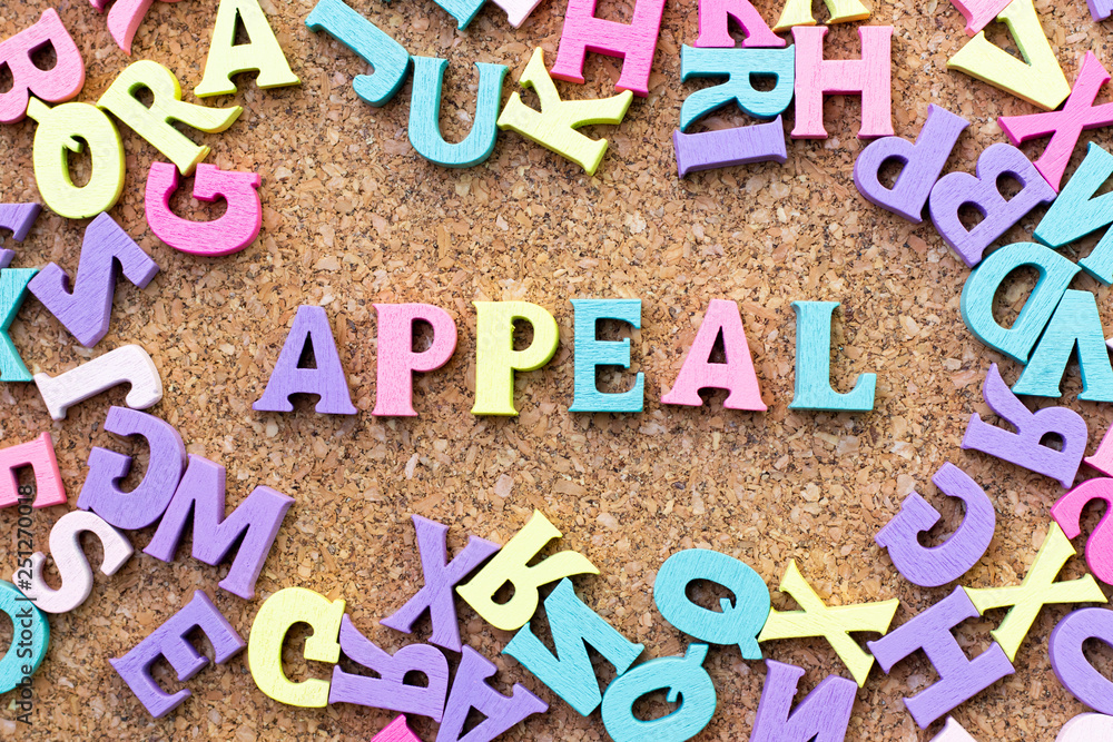 Color alphabet in word appeal with another letter as frame on cork ...