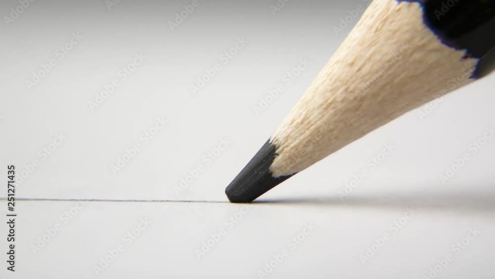 extreme close up of architect or artist draws a line in pencil ...