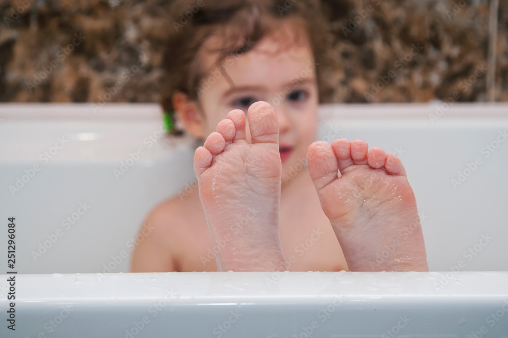 Wrinkled bare baby girl feet coming out from a bathtub. Stock Photo ...