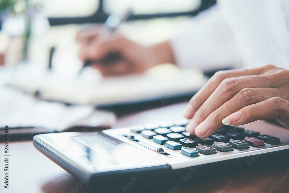 Woman with bills and calculator. Woman using calculator to calculate ...