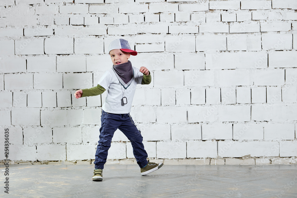 Cool child boy hip hop actively dancing to the music. Cute fashionable ...
