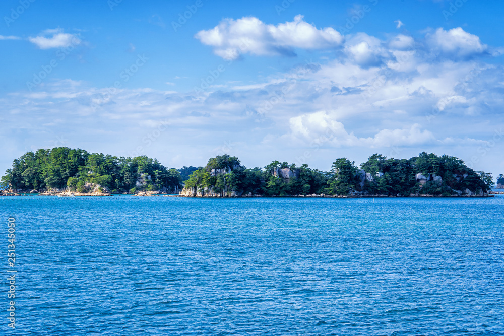 Many small islands over the blue ocean in sunny day, famous Kujukushima ...