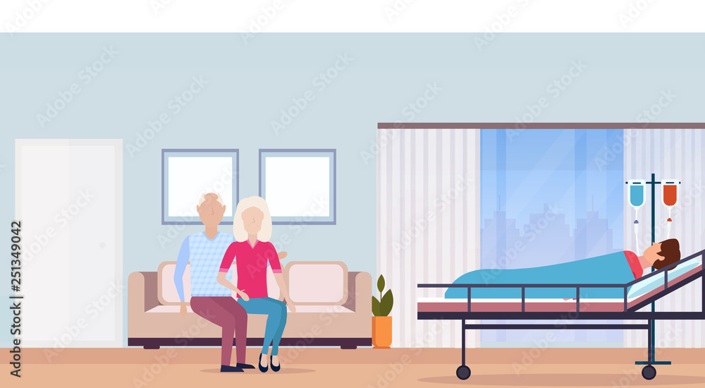 couple man woman visiting patient man lying bed intensive therapy ward ...