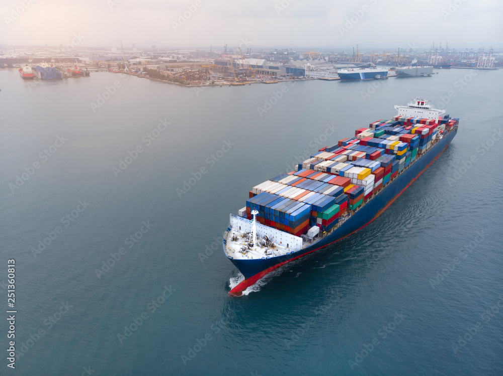 Aerial of cargo ship carrying container and running for export and ...