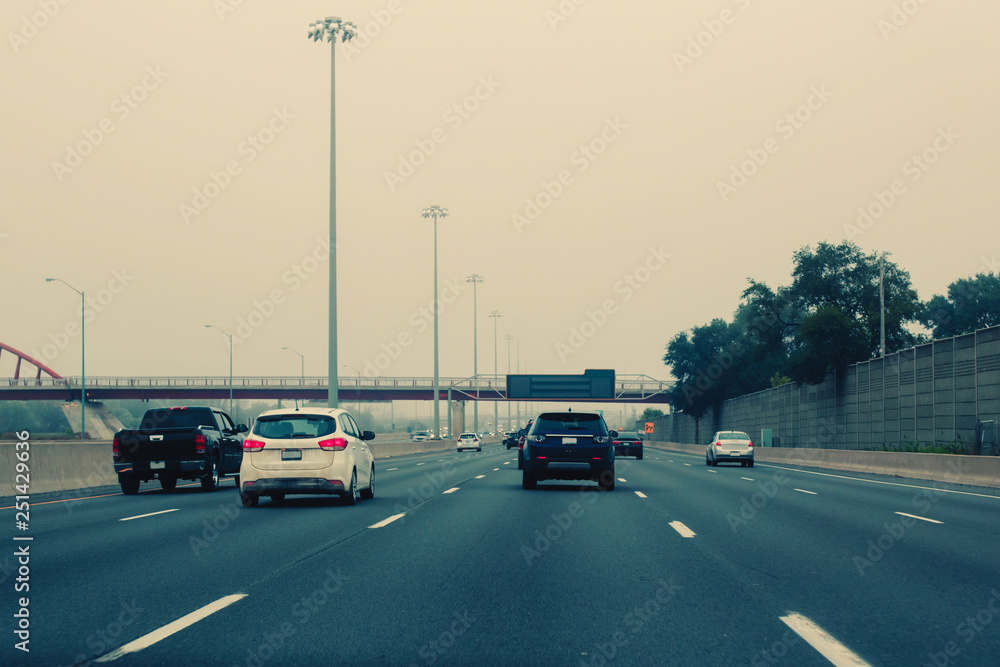Traffic on highway in fog mist. Cars on freeway road at evening in ...