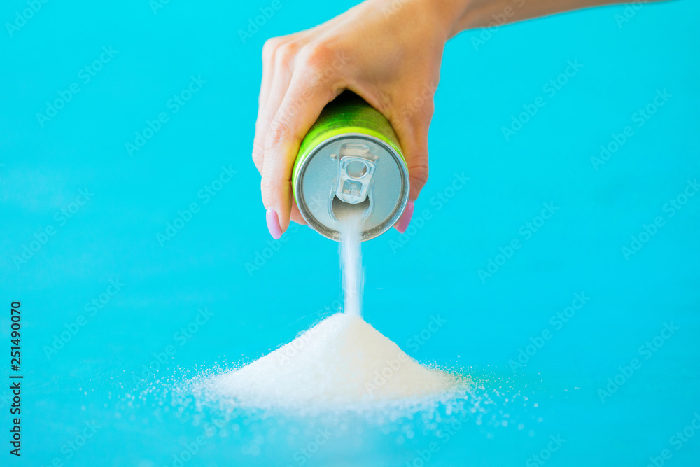 Person pouring sugar out of soft drink can Stock Photo | Adobe Stock
