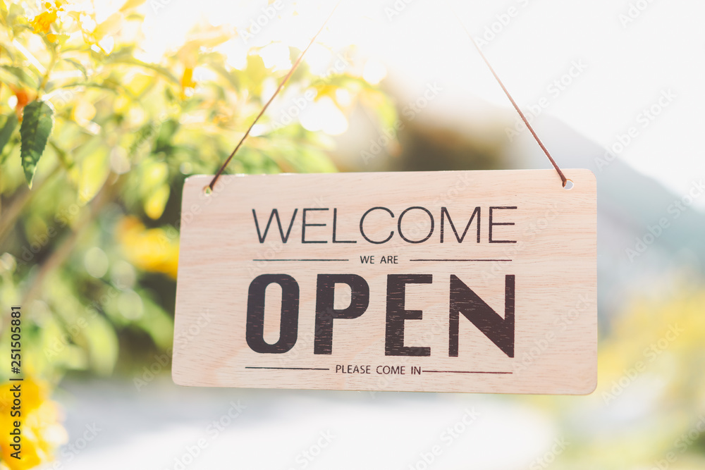 Wooden open sign hanging on tree with green nature bokeh sunlight ...