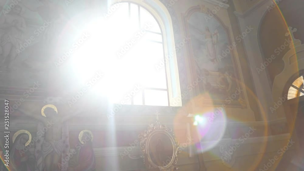Sun light passes through the stained glass windows of the church. Blick ...