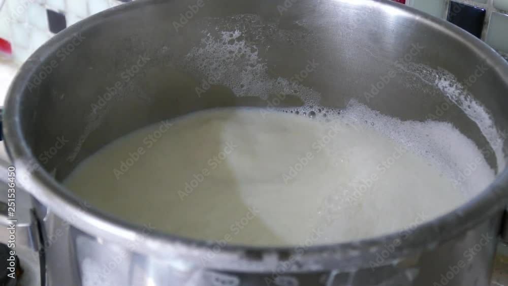 cook natural organic milk, boil the milk in pots, milk that is about to ...