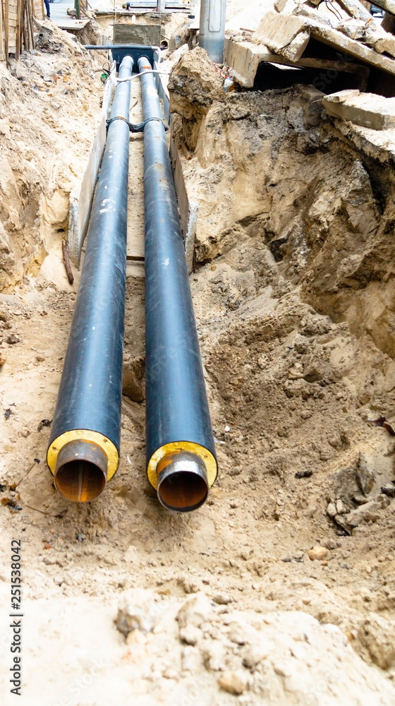 Water pipes in ground pit trench ditch during plumbing under ...