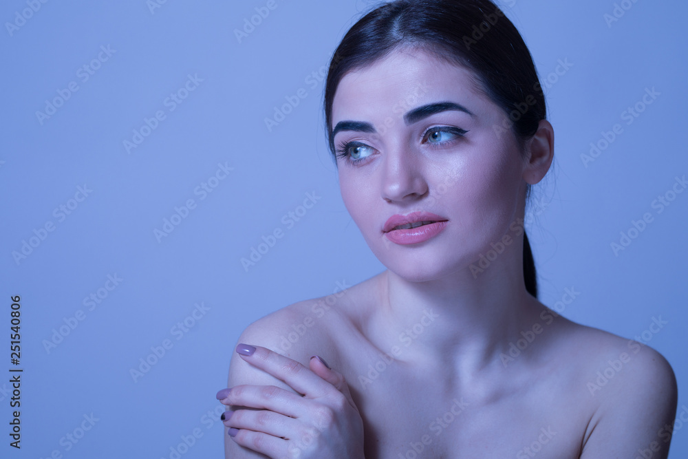 Beautiful Face Of A Young Woman With Clean Fresh Skin Isolated On Light