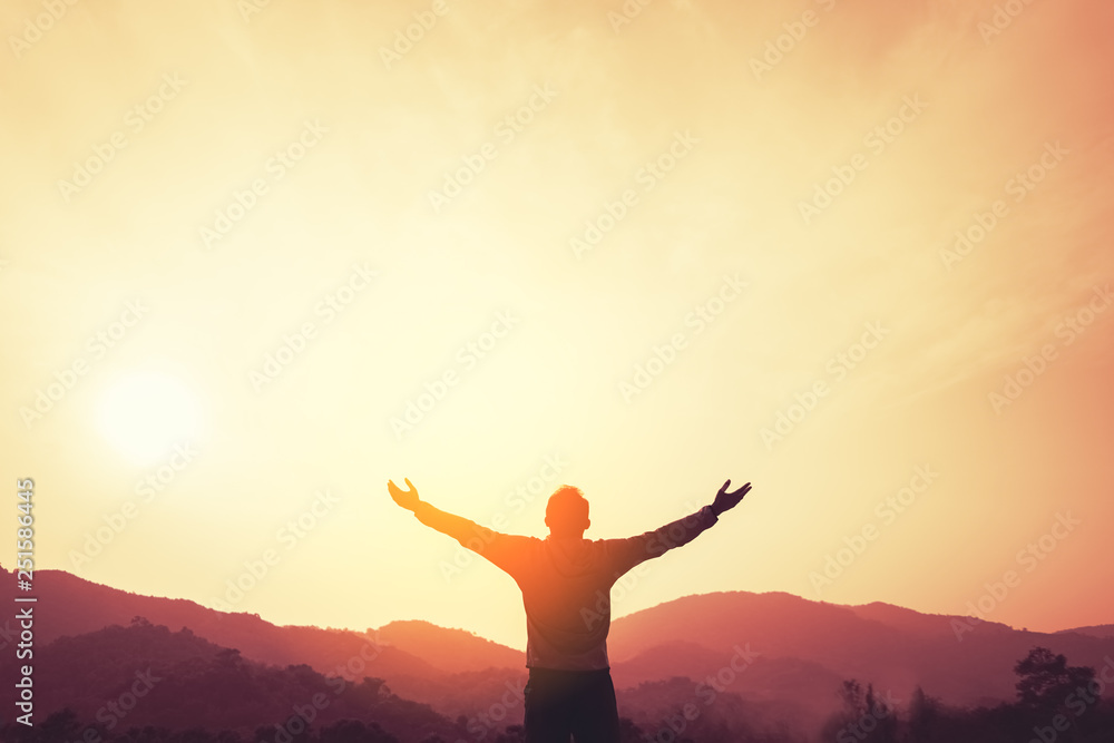 Copy space of man rise hand up on top of mountain and sunset sky ...