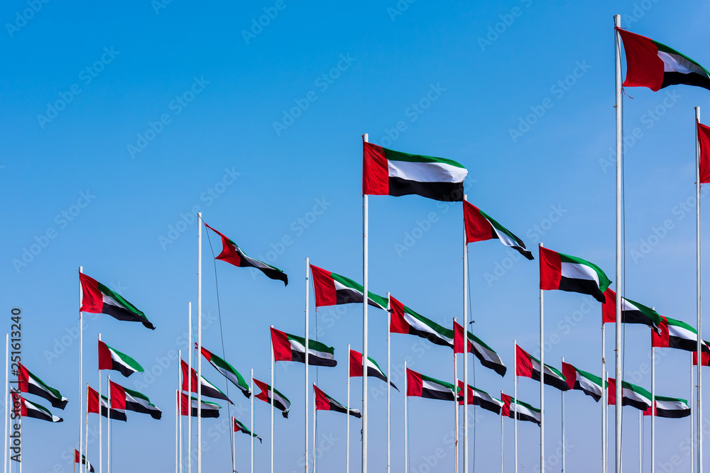 United Arab Emirates flags winding in the wind against blue sky Stock ...
