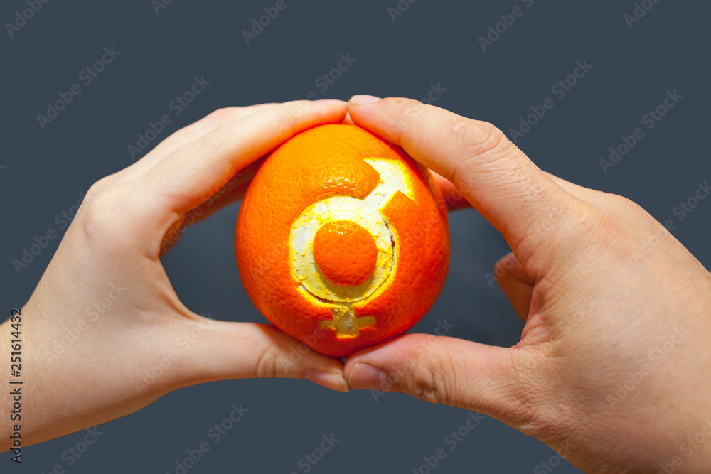 Foto de Gender equality. Orange with the sign of gender equality in the ...
