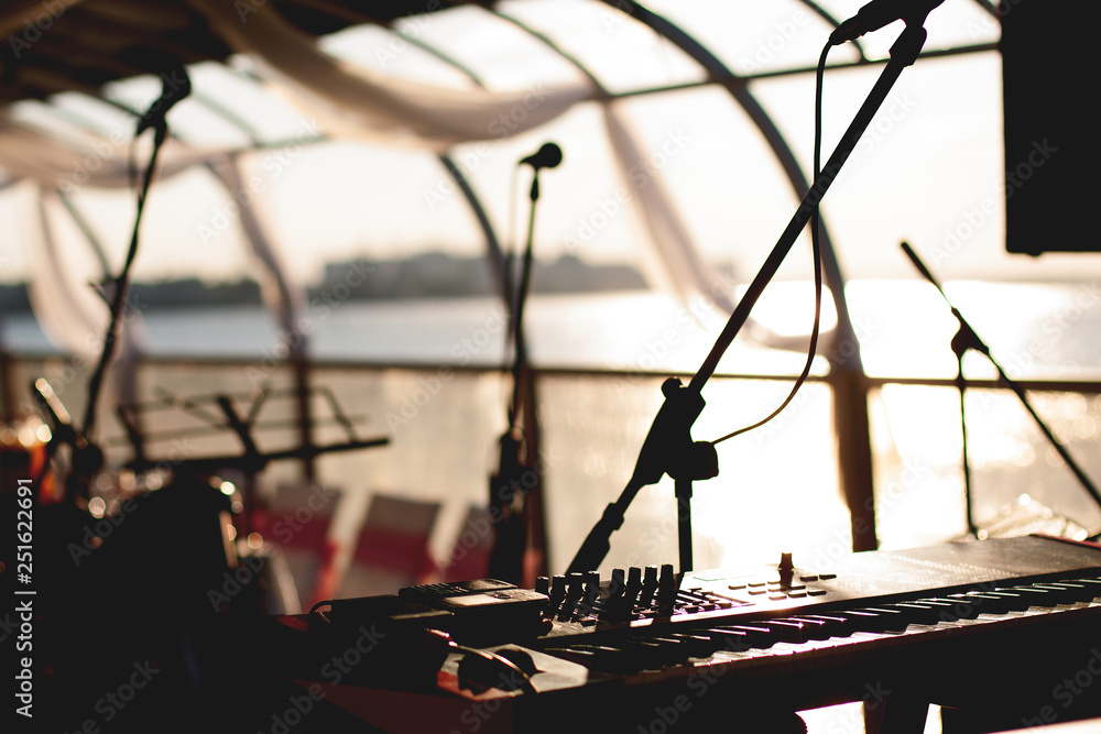 Musical instruments in the bar. Synthesizer and Microphone Stands ...