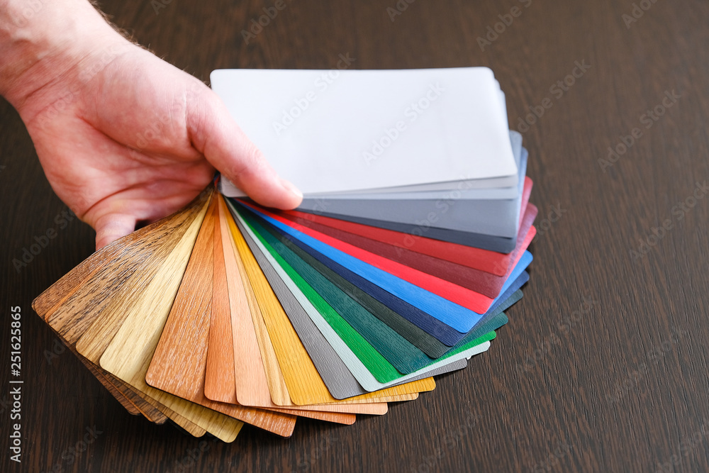 Samples of lamination deployed, the master holds in his hand. On a ...