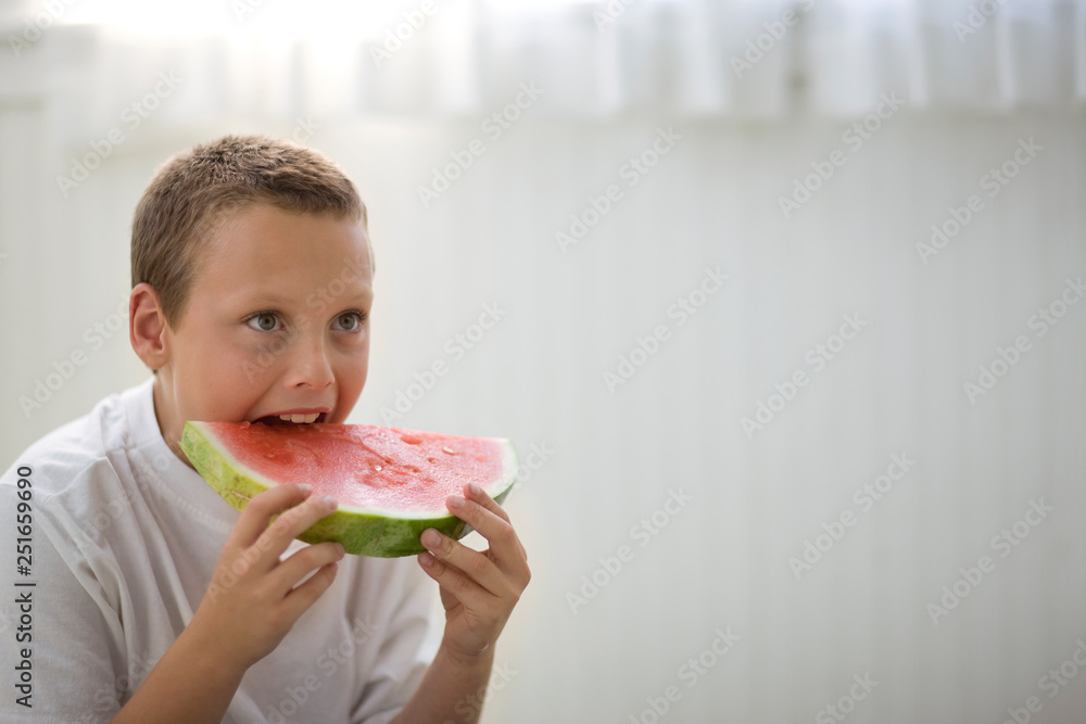 Young boy taking a big bite out of a juicy slice of watermelon. Stock ...