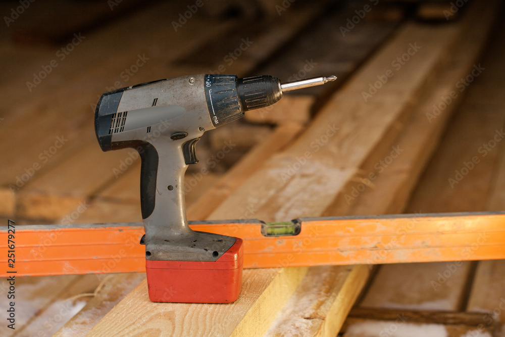 Cordless drilling tool using to build a wooden house. Construction tool ...