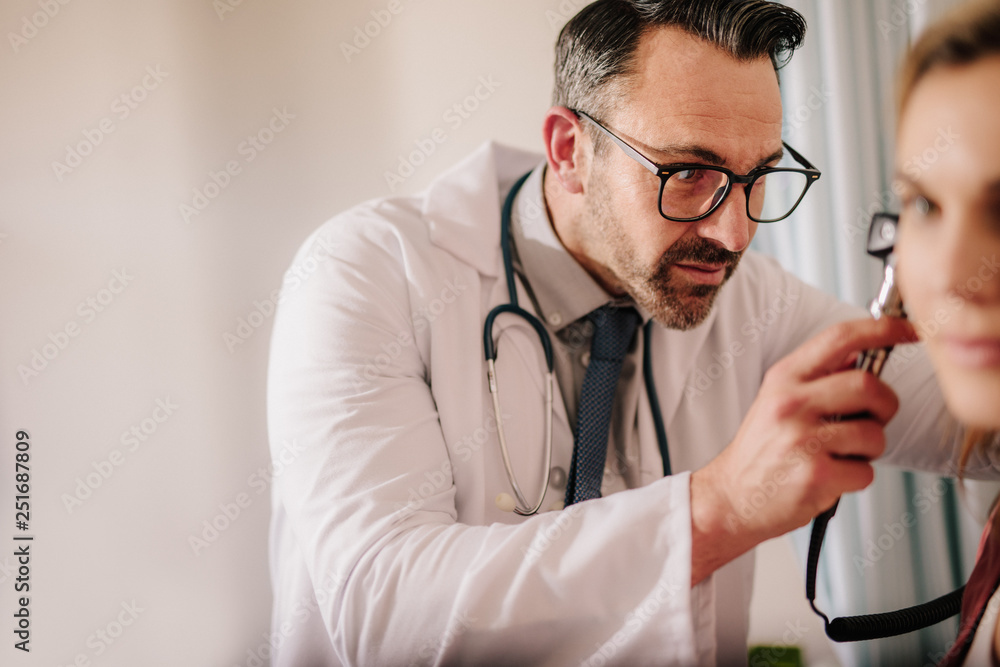 ENT doctor doing ear examination of patient Stock Photo | Adobe Stock