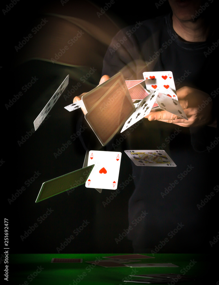 Card dealing / throwing, with motion trails on a black background Stock ...